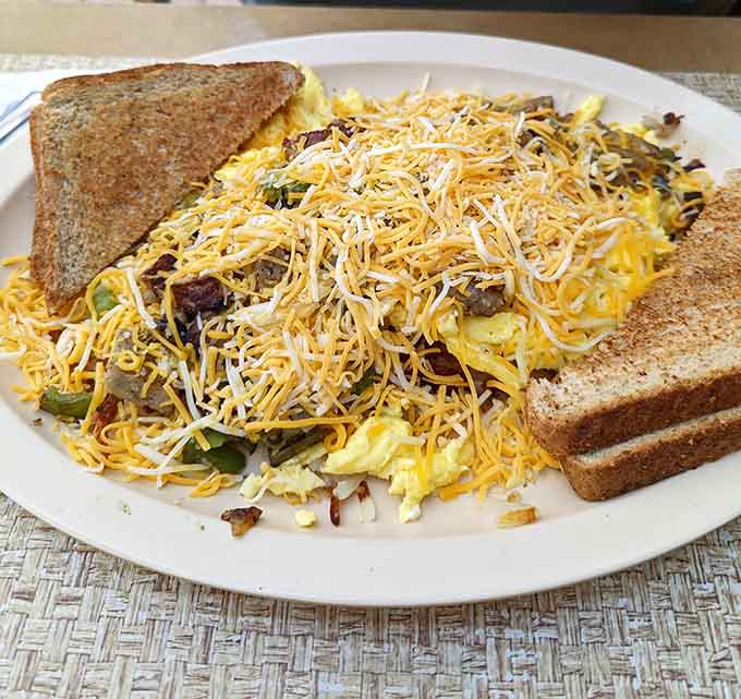 Sheila's Scramble piles eggs, sausage, peppers, and cheese into one glorious mountain of breakfast happiness.