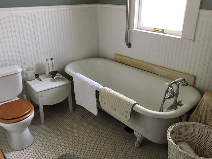 A clawfoot tub with penny tile floors and beadboard walls. Your bathroom at home just became deeply embarrassing by comparison.