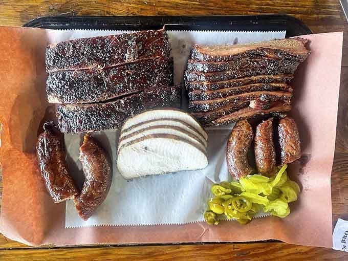 A full tray of brisket, ribs, turkey, and sausage with pickled peppers, because moderation is overrated on Saturdays.