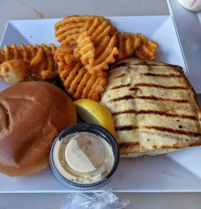Grilled fish sandwich with waffle fries and a side of "why haven't I been coming here my whole life."