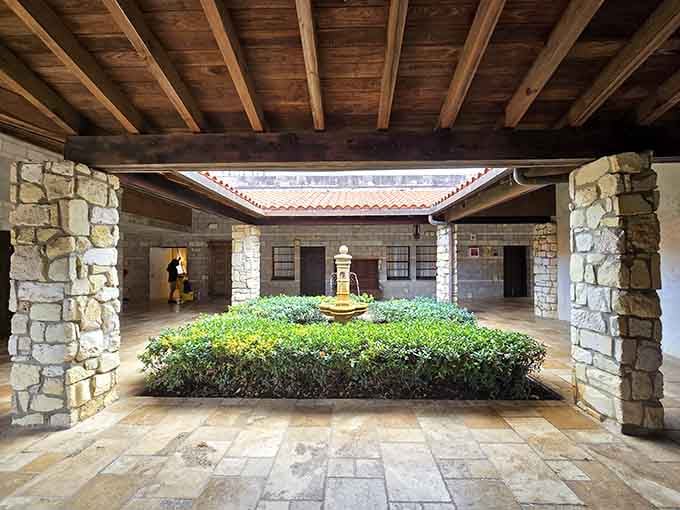 A courtyard fountain surrounded by wooden beams and stone columns proves that simple beauty never goes out of style.