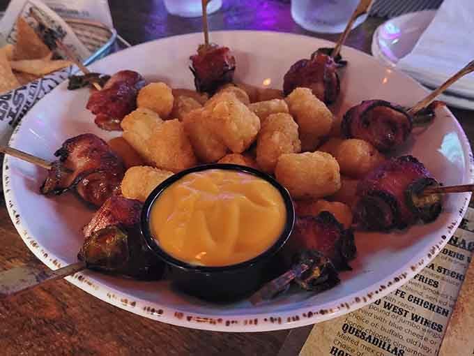 Bacon-wrapped delights and tater tots arranged like edible art, because sometimes presentation matters even in a haunted saloon.