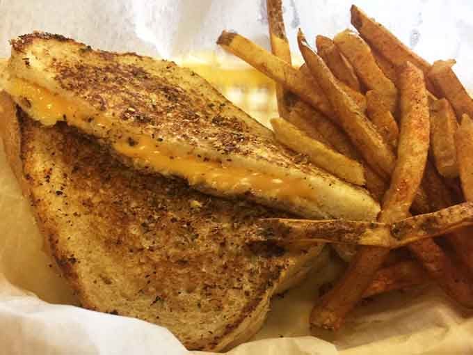 That perfectly grilled sandwich oozes melted cheese like it's auditioning for a food commercial, and it's got the part.