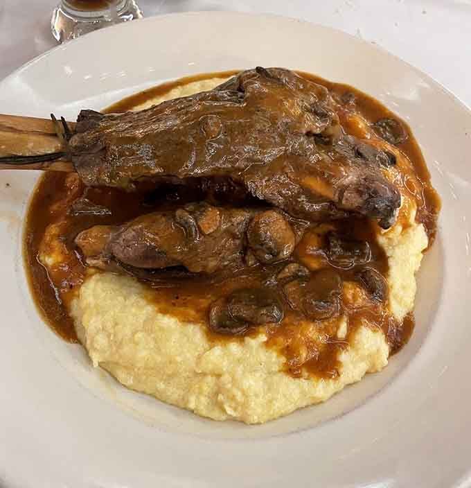 Lamb osso bucco perched on creamy polenta, swimming in rich gravy. This dish means serious, glorious business.