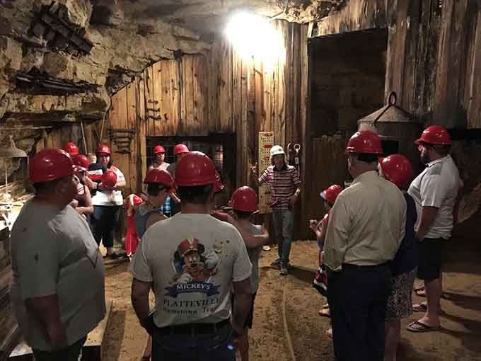 Red helmets, rock walls, and a guide who clearly loves this place — underground school is officially in session.