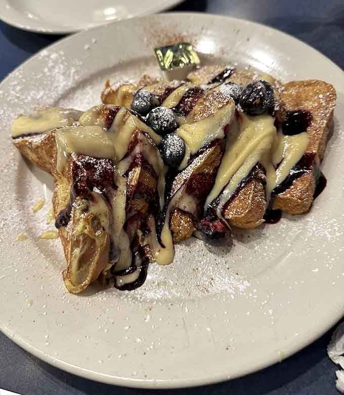 French toast topped with blueberries and drizzled with cream sauce, because some mornings deserve to be treated like a special occasion.