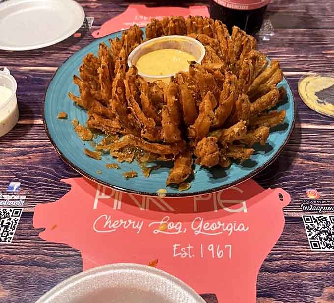 The Oink Onion arrives like a crispy, golden crown, and yes, you will eat every single petal without apology.