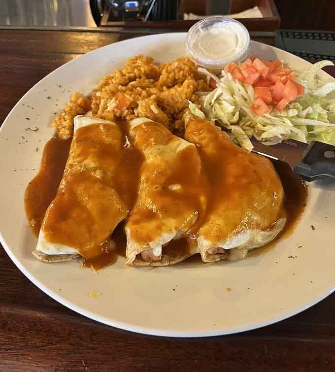 Chicken enchiladas smothered in sauce and served with crinkle fries&mdash;because sometimes fusion means doing whatever makes people ridiculously happy.
