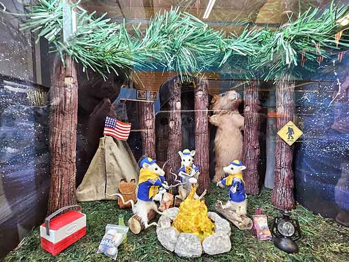 Three cub scout mice roasting marshmallows, completely unaware that something very large is lurking behind the trees.