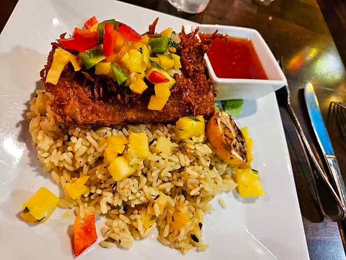 Blackened mahi crowned with bright pineapple salsa and grilled asparagus, a plate that genuinely earns its applause.
