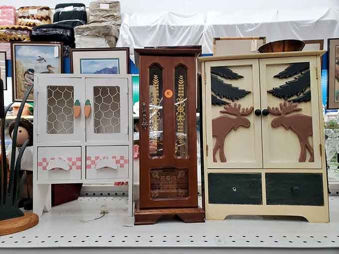 Three charming decorative cabinets side by side, including one with a moose, because why not have a moose.