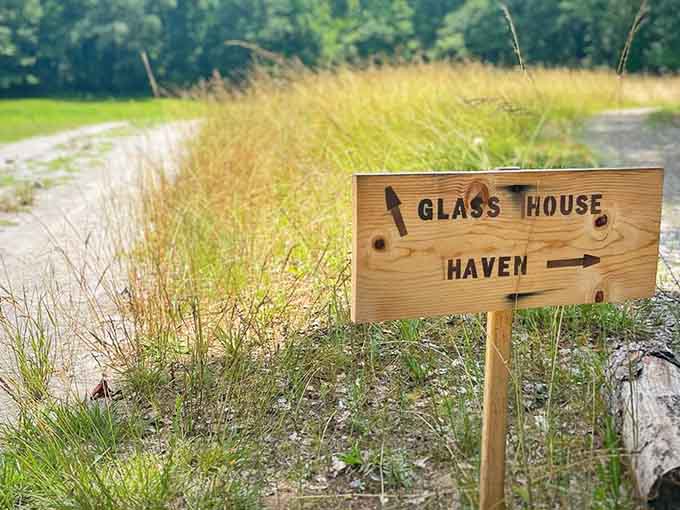 A handmade wooden sign pointing toward the Glass House and Haven. Best directions you'll ever follow in Georgia.