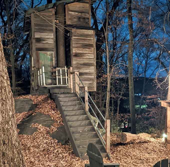 Wooden stairs climbing toward a glowing green door at dusk, this entrance feels like the opening scene of a very good dream.