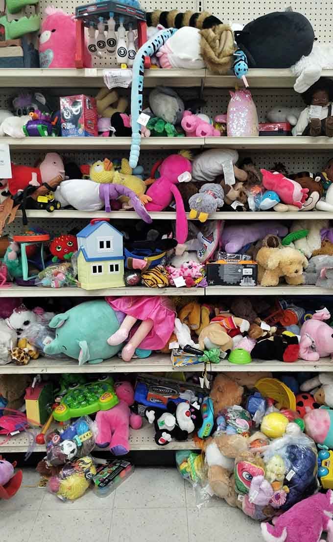 Six shelves of pure childhood chaos, stuffed animals piled high like a plush toy avalanche in progress.