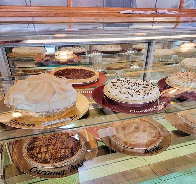 A whole display case of homemade pies, including lemon meringue, chocolate cream, caramel apple, and classic apple. This is not a drill.
