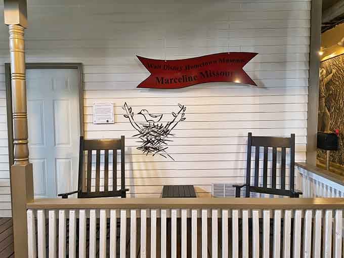 Two rocking chairs, a hand-painted bird, and a sign that says it all. This porch knows exactly what it is.