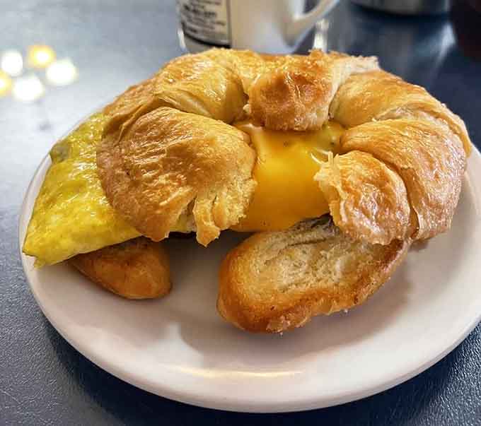 Melted cheese spilling out of a flaky croissant like it has somewhere important to be. Morning goals, achieved.