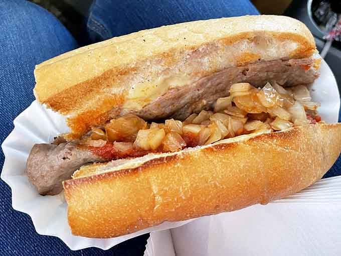 Golden caramelized onions draped over a hearty steak in a crusty roll, this cheesesteak is the real deal.