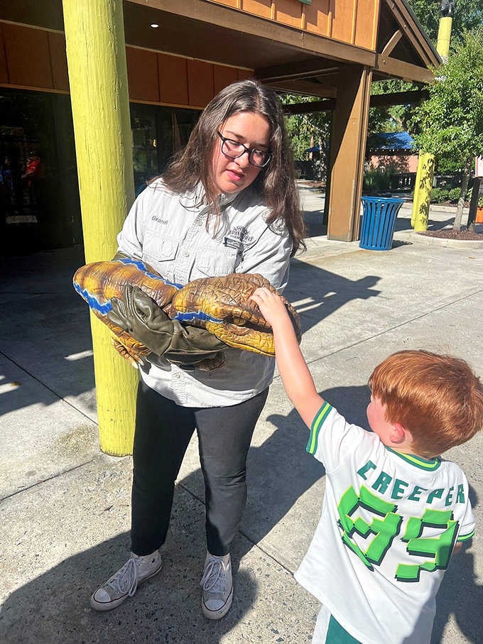 When a staff member hands a kid a baby Velociraptor puppet, pure joy happens instantly and loudly.
