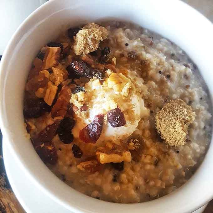 Quinoa oatmeal topped with dried fruit, nuts, and brown sugar. Wholesome never had this much personality on a spoon.
