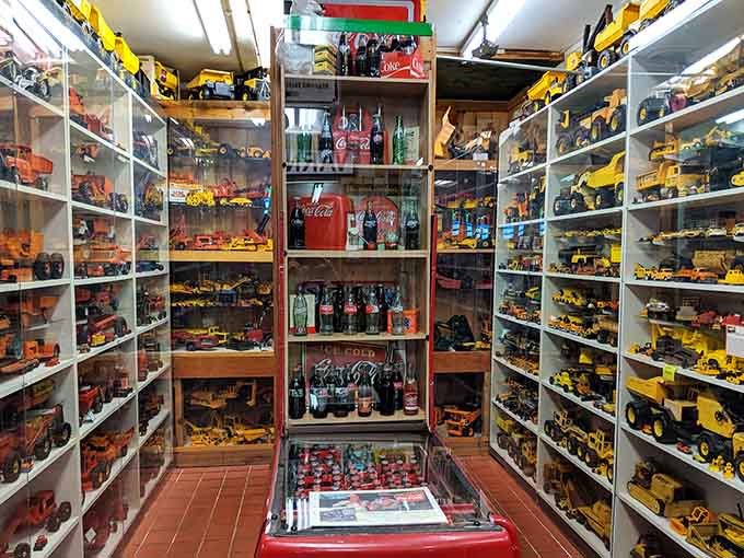 Rows of toy construction vehicles at the World's Largest Toy Museum Complex, lined up like the world's most organized job site.