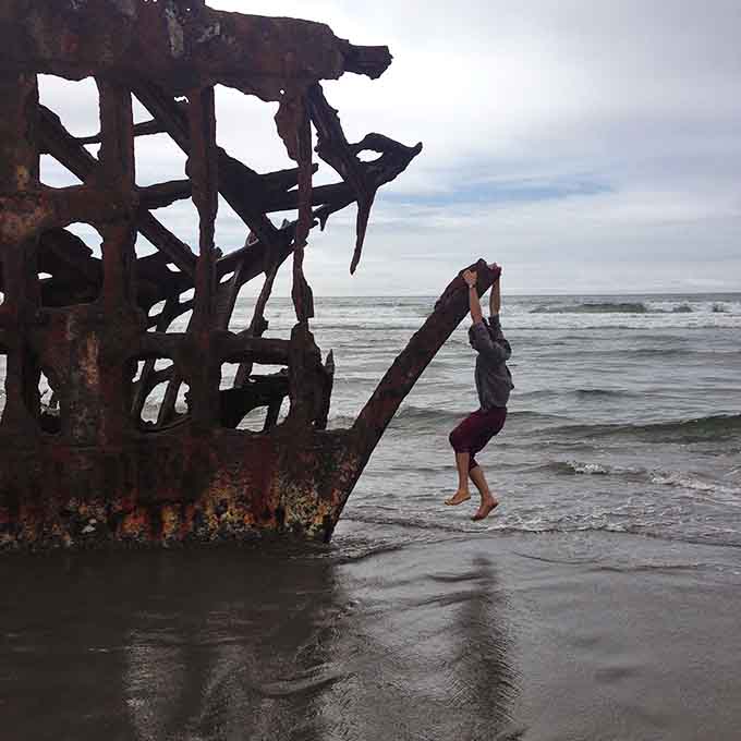 When the shipwreck becomes your personal jungle gym, you know Oregon beaches play by different rules entirely.