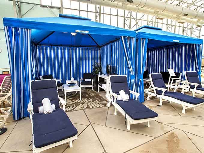 These blue-striped cabanas have the kind of quiet, cushioned dignity that makes you feel like a dignitary on a very fun vacation.