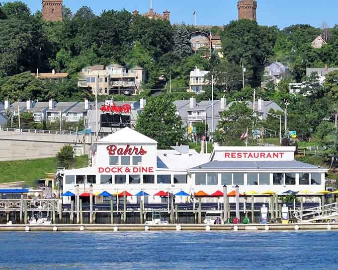 Colorful umbrellas, a sparkling waterfront, and that bold red Bahrs sign make this Highlands landmark look like a postcard that feeds you.