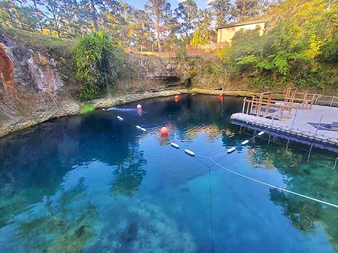 Orange buoys marking the dive zones at golden hour, this limestone sinkhole looks like it was designed by someone with very good taste.
