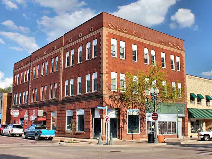 That three-story red brick corner building in Fairmont means business, literally, with its decorative diamond details catching the afternoon sun beautifully.