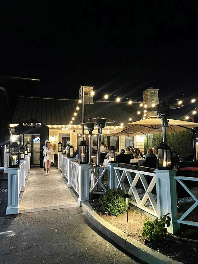 String lights, lantern-lined walkways, and a buzzing patio make Gabriele's nighttime atmosphere feel genuinely magical and warm.