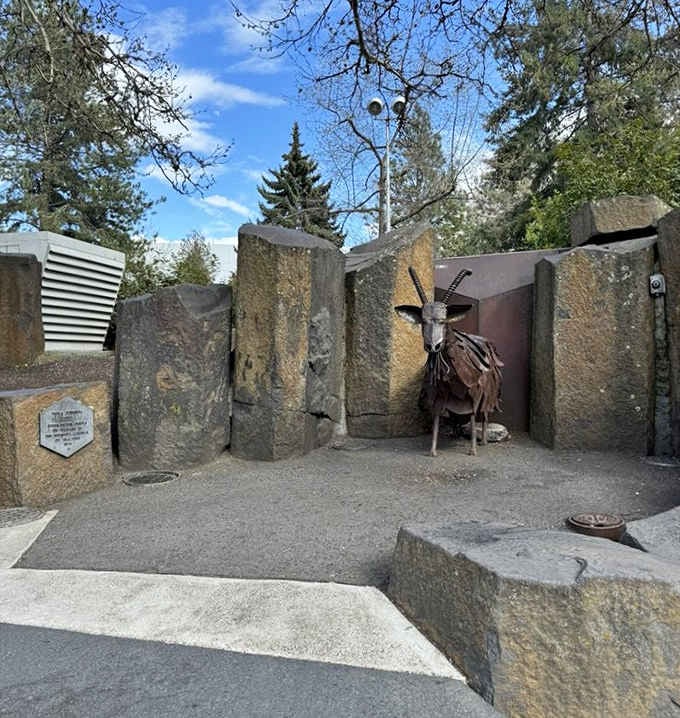Surrounded by massive boulders, this steel goat stands its ground with the quiet confidence of a Riverfront Park legend.