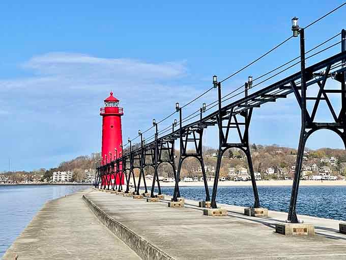 That brilliant red lighthouse stands like a beacon of hope, guiding you toward the perfect lakeside afternoon.