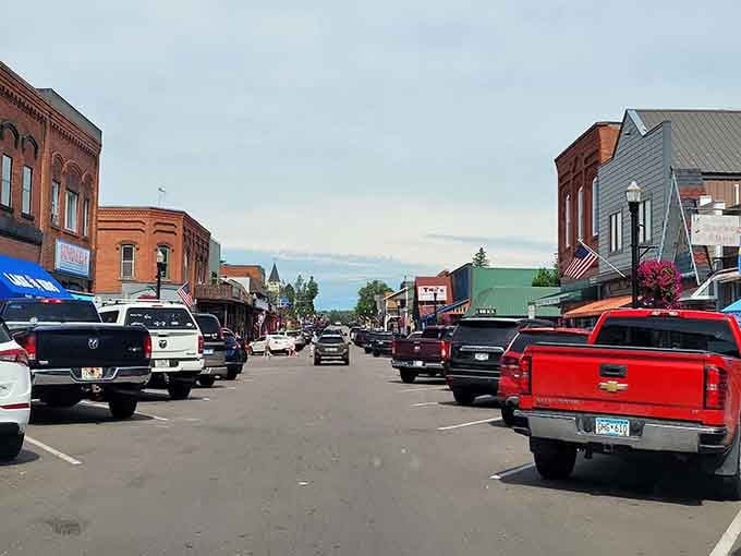 Pickup trucks parked along brick storefronts tell you this town is authentically lived-in, not staged.
