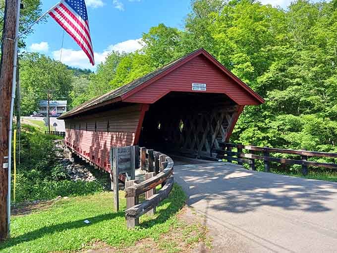That American flag waving beside the red entrance says everything about how proudly this community claims its remarkable wooden landmark.