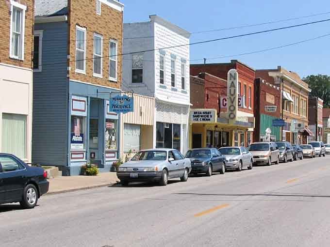 Nauvoo's main street hums with everyday small-town life, the vintage theater marquee adding a nostalgic wink to the whole charming scene.