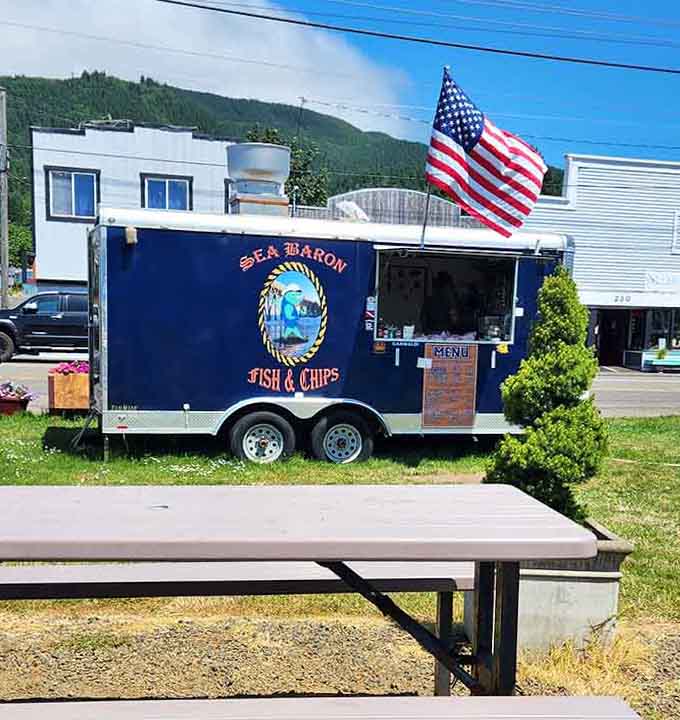 This bold navy trailer parked under an American flag is basically a patriotic fish fry waiting to happen.