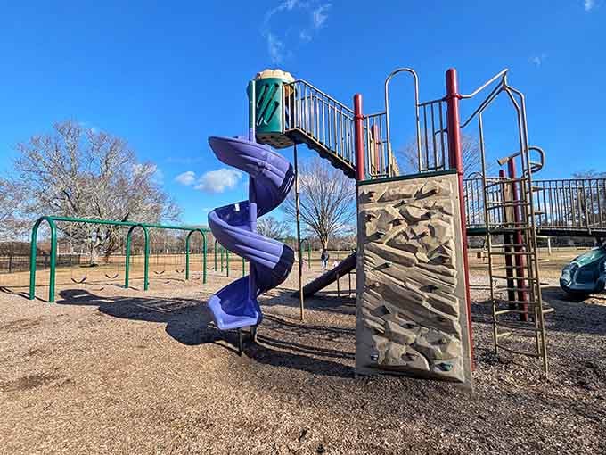 Rock climbing meets playground fun where kids can test their skills before racing to the swings nearby.