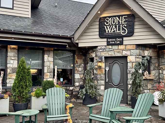 Green Adirondack chairs, a crackling fire, and real stone walls that whisper "settle in, dinner's going to be wonderful."
