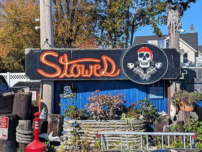 A pirate skull wearing a bandana greets you with nautical ropes and weathered wood, because seafood should be fun.