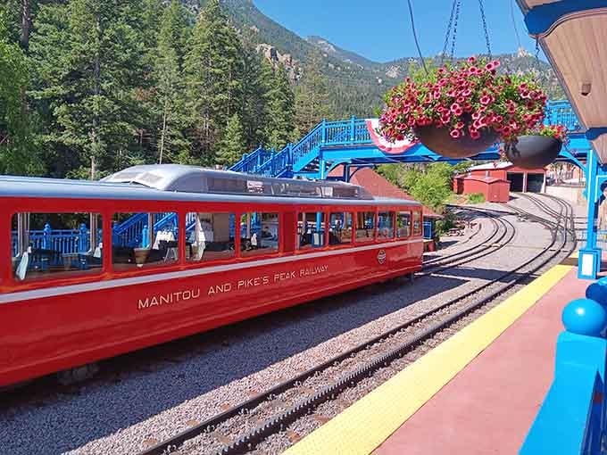 That sleek red train at Manitou Springs station is basically a first-class ticket to the top of the world.