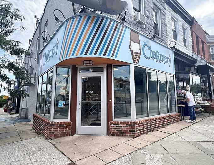 The Charmery's bold striped awning on a Baltimore corner is the kind of visual that stops you mid-stride immediately.
