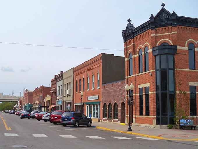 Ornate cornices crown these brick buildings like architectural jewelry from the Victorian era's golden age.