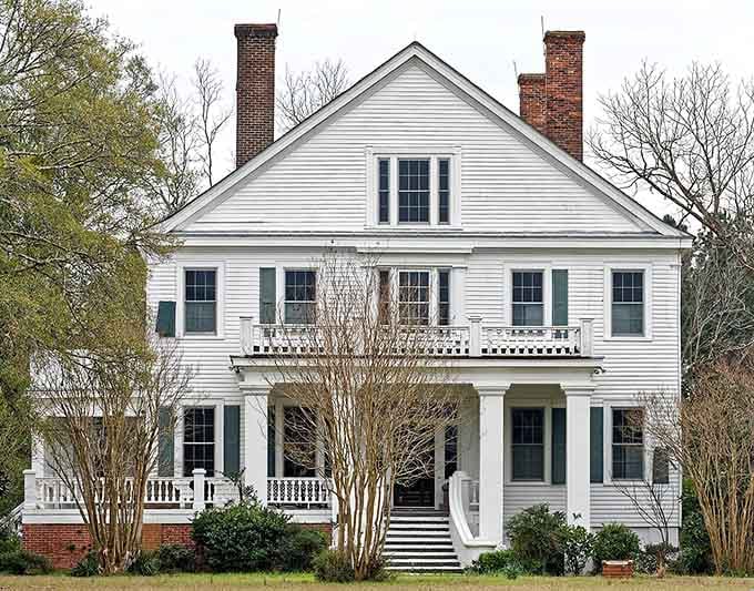 This grand white Allendale home, with its double porches and twin chimneys, is the kind of place that makes you rethink everything.