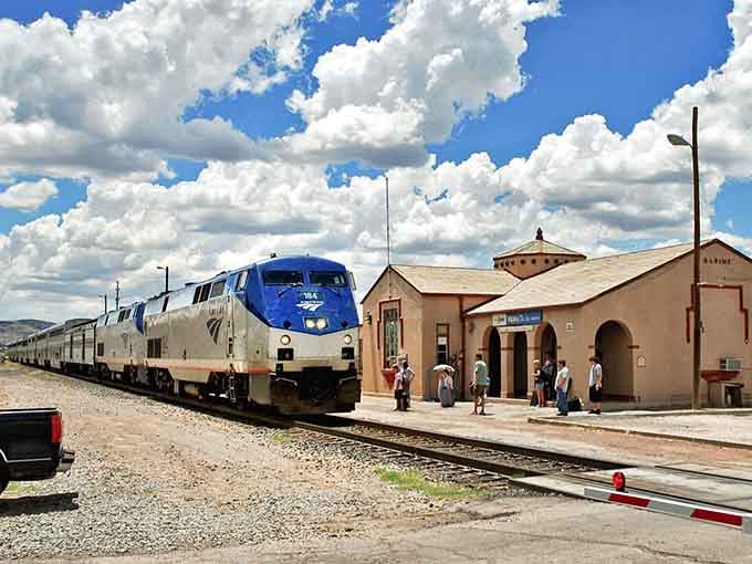 Travelers gathering on the platform at Alpine's depot look like characters in a movie where the scenery steals every scene.