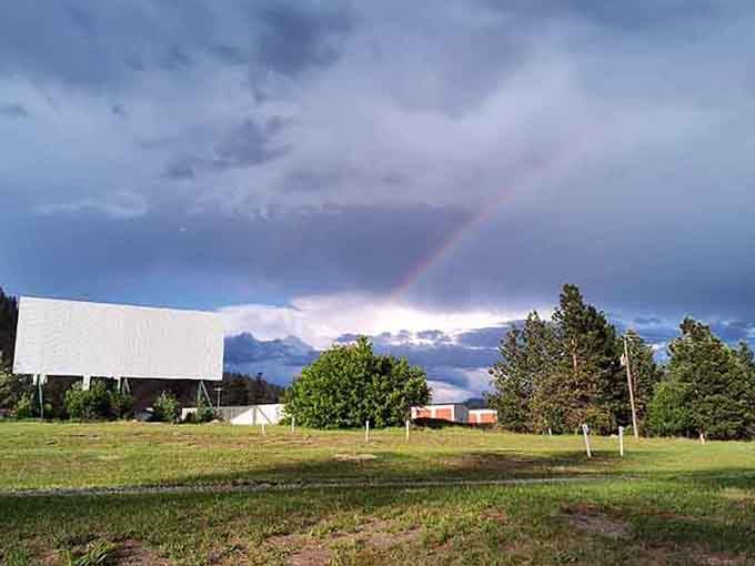A rainbow arcs over the drive-in theater like nature's own special effect approving this nostalgic entertainment choice.