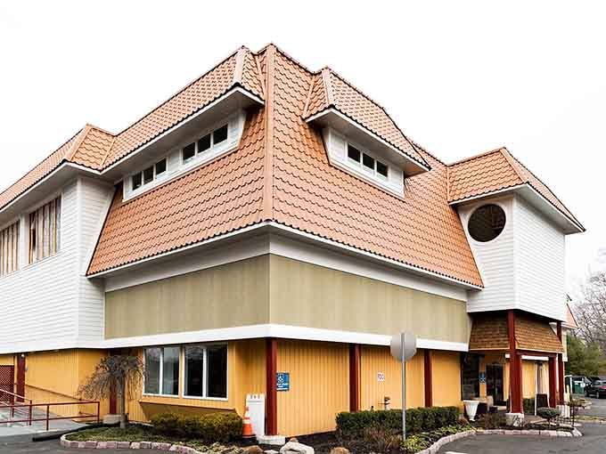 That terracotta roofline is doing a lot of heavy lifting, and honestly, it's pulling it off beautifully.