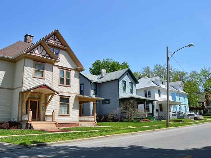 Charming Victorian homes line a Decatur street under a brilliant blue sky, where front porches practically beg you to sit down.