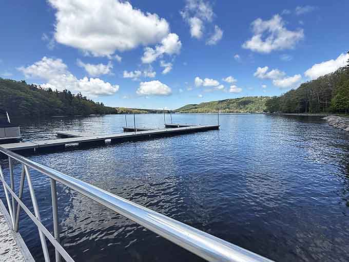 From the marina dock, Deep Creek Lake opens wide and brilliant beneath a gorgeous blue sky full of rolling white clouds.