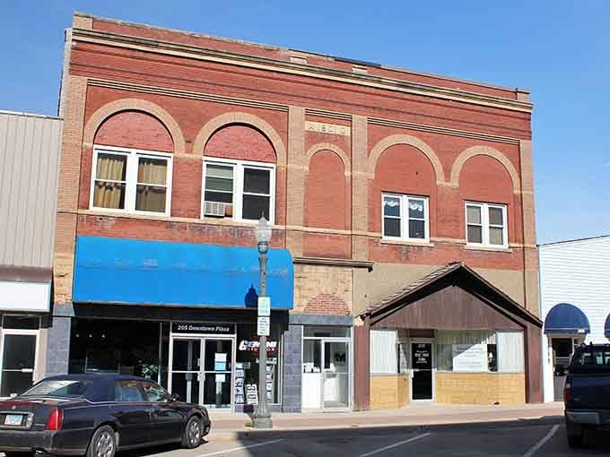 A bold blue awning and arched brick windows give this Fairmont storefront the kind of no-nonsense character that only decades of Main Street life can build.